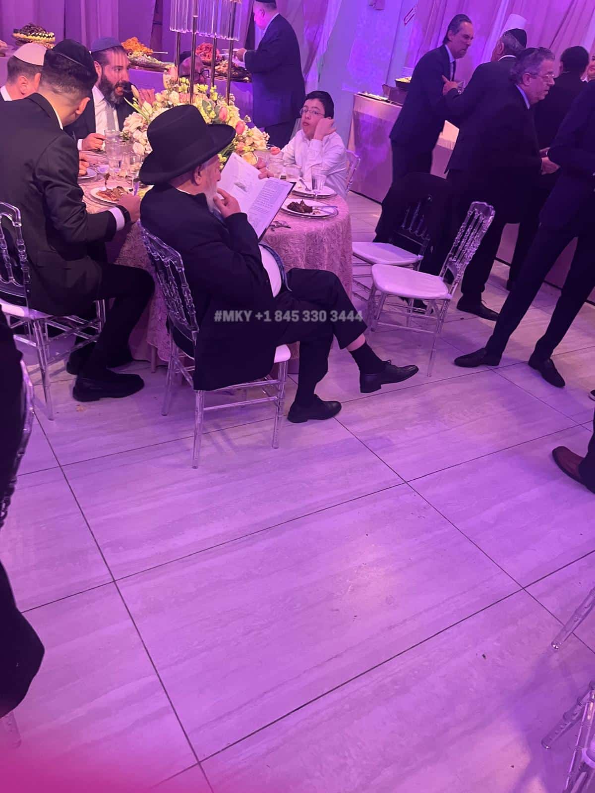At a wedding, Rav Max Masalton in a joyous realm before the chassan and ...